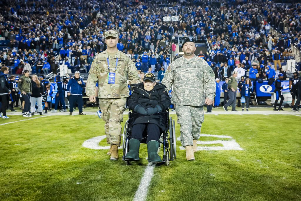A 102-year-old WWII vet, BYU fan flips game coin at Veterans Day game